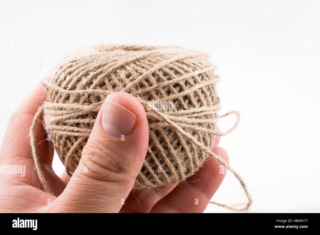 Spools of thread in hand isolated on a white background Stock Photo - Alamy