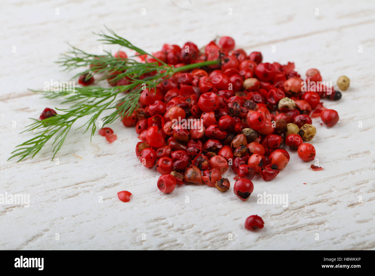 Red pepper corn on the wood background Stock Photo - Alamy