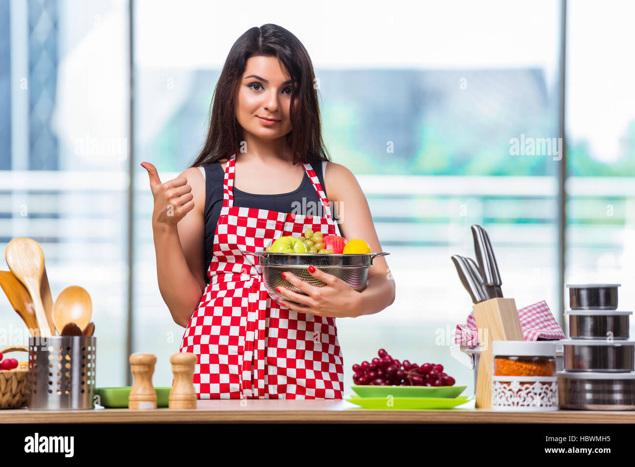 Young cook with fruits in the kitchen Stock Photo - Alamy