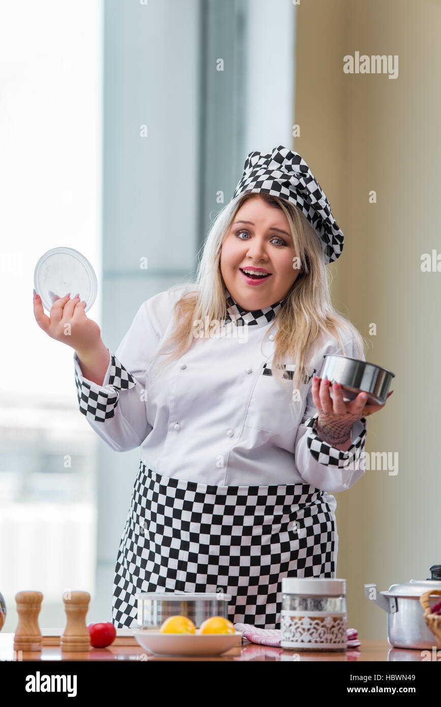 Woman cook working in the bright kitchen Stock Photo - Alamy