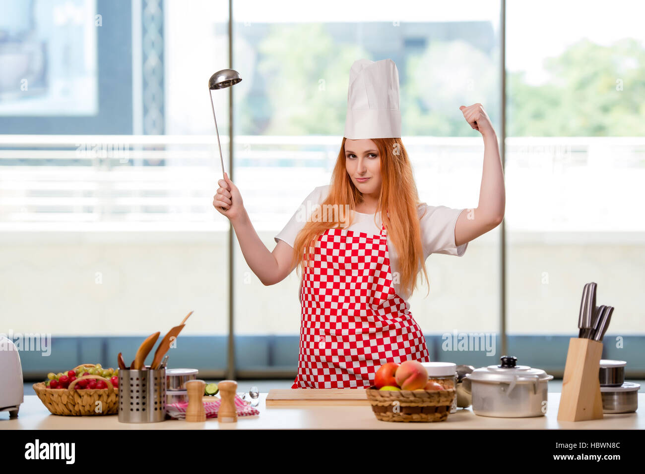 Redhead cook working in the kitchen Stock Photo - Alamy