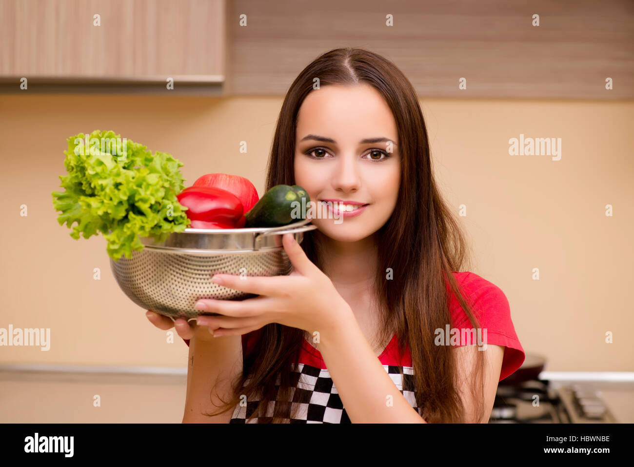 Young woman housewife working in the kitchen Stock Photo - Alamy