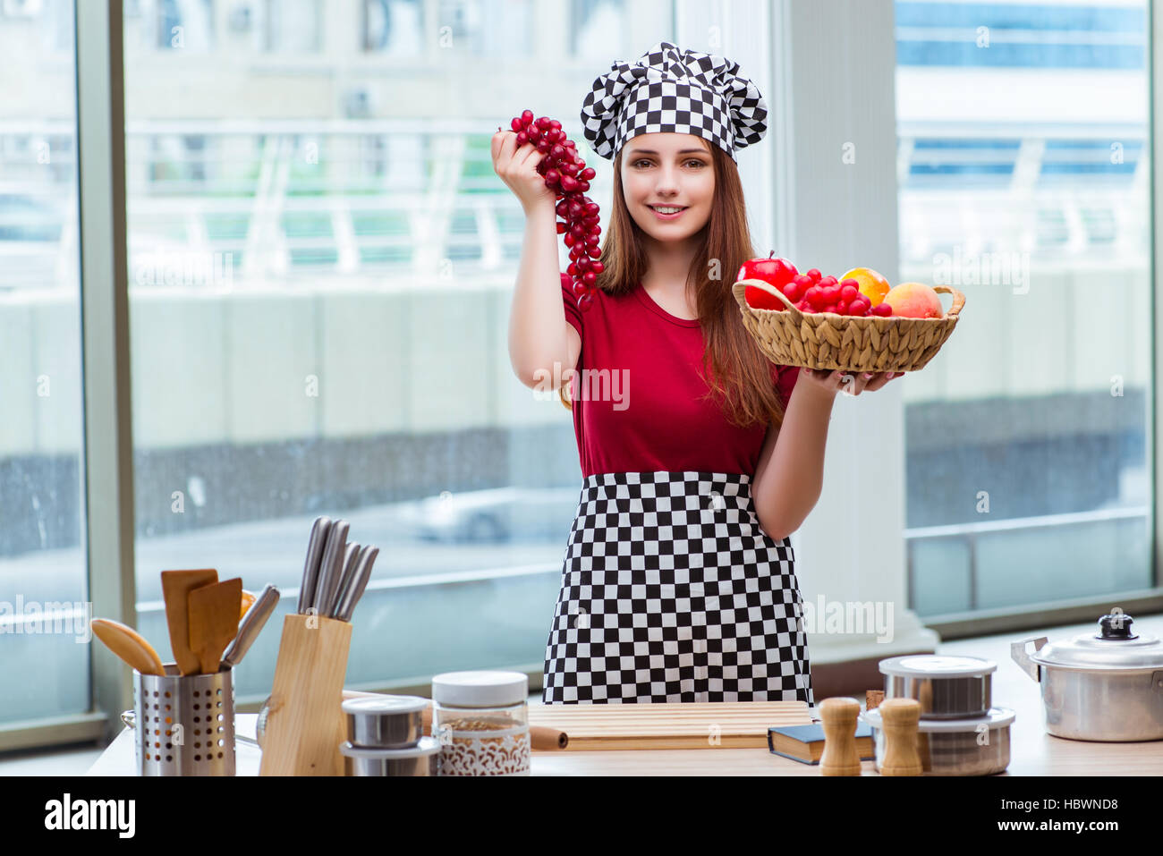 Young cook with fruits in the kitchen Stock Photo - Alamy