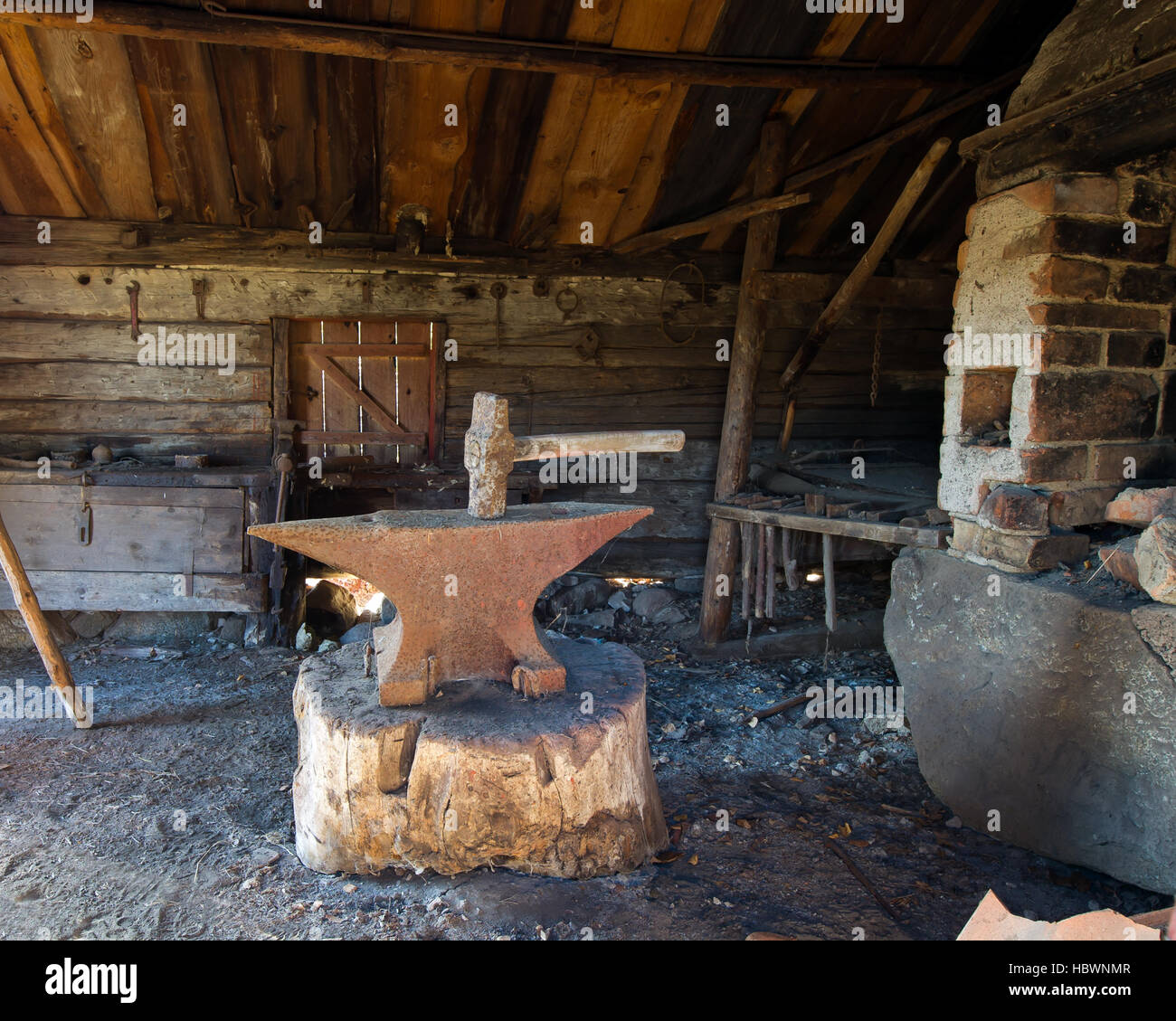 Blacksmiths tools, the hammer and the anvil in a central place in the old Blacksmiths workshop ...