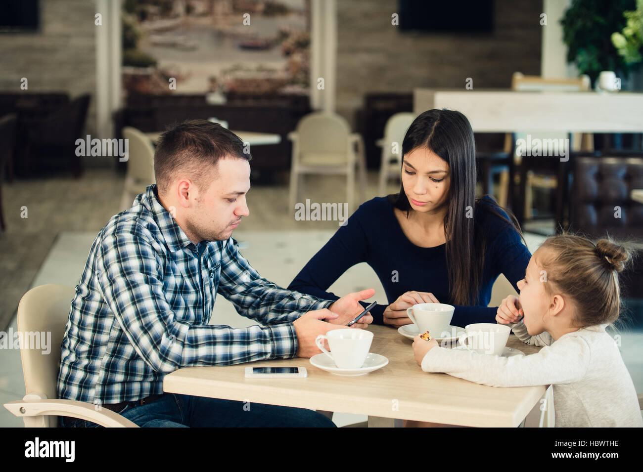 Family Enjoying tea In Cafe Together Stock Photo - Alamy