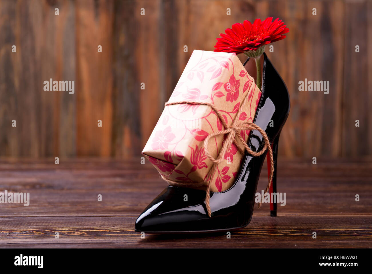 Wrapped gift and heel shoe Stock Photo - Alamy