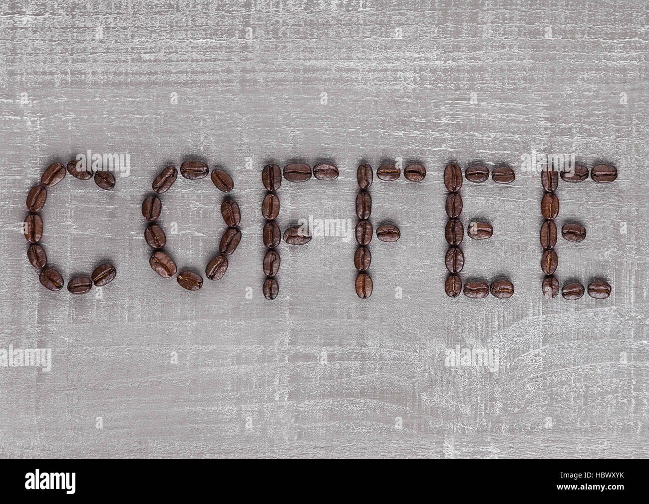 Coffee letters sign made from fresh coffee beans on wooden background ...