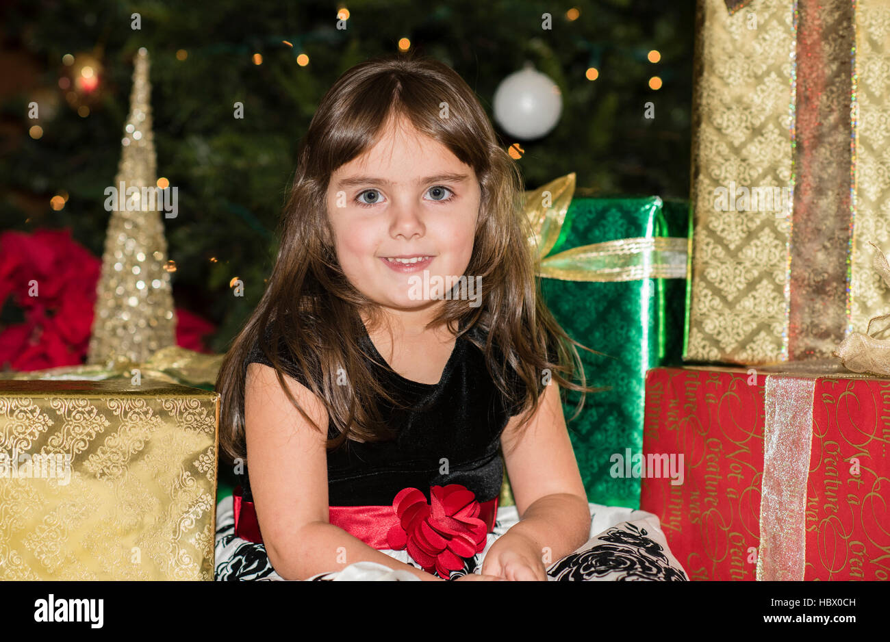 Little Girl with Christmas Tree, Presents & Lights Stock Photo - Alamy