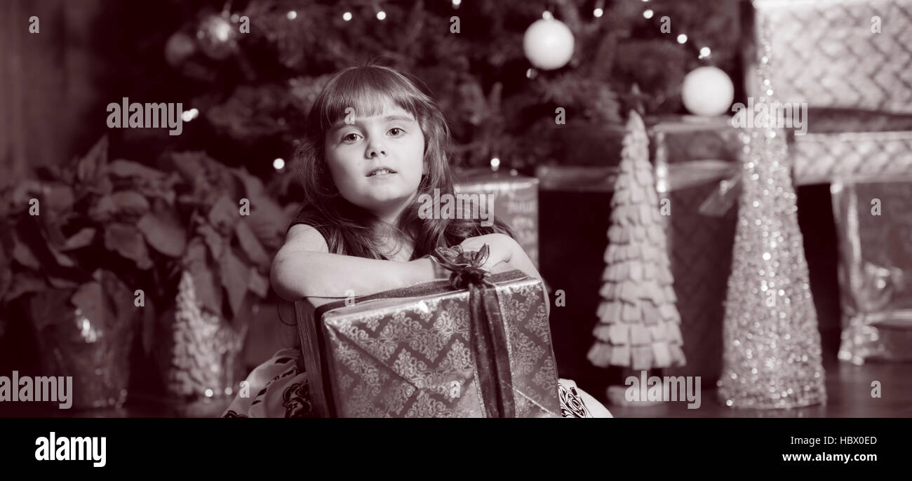 Little Girl with Presents, Christmas Tree and Lights Stock Photo - Alamy