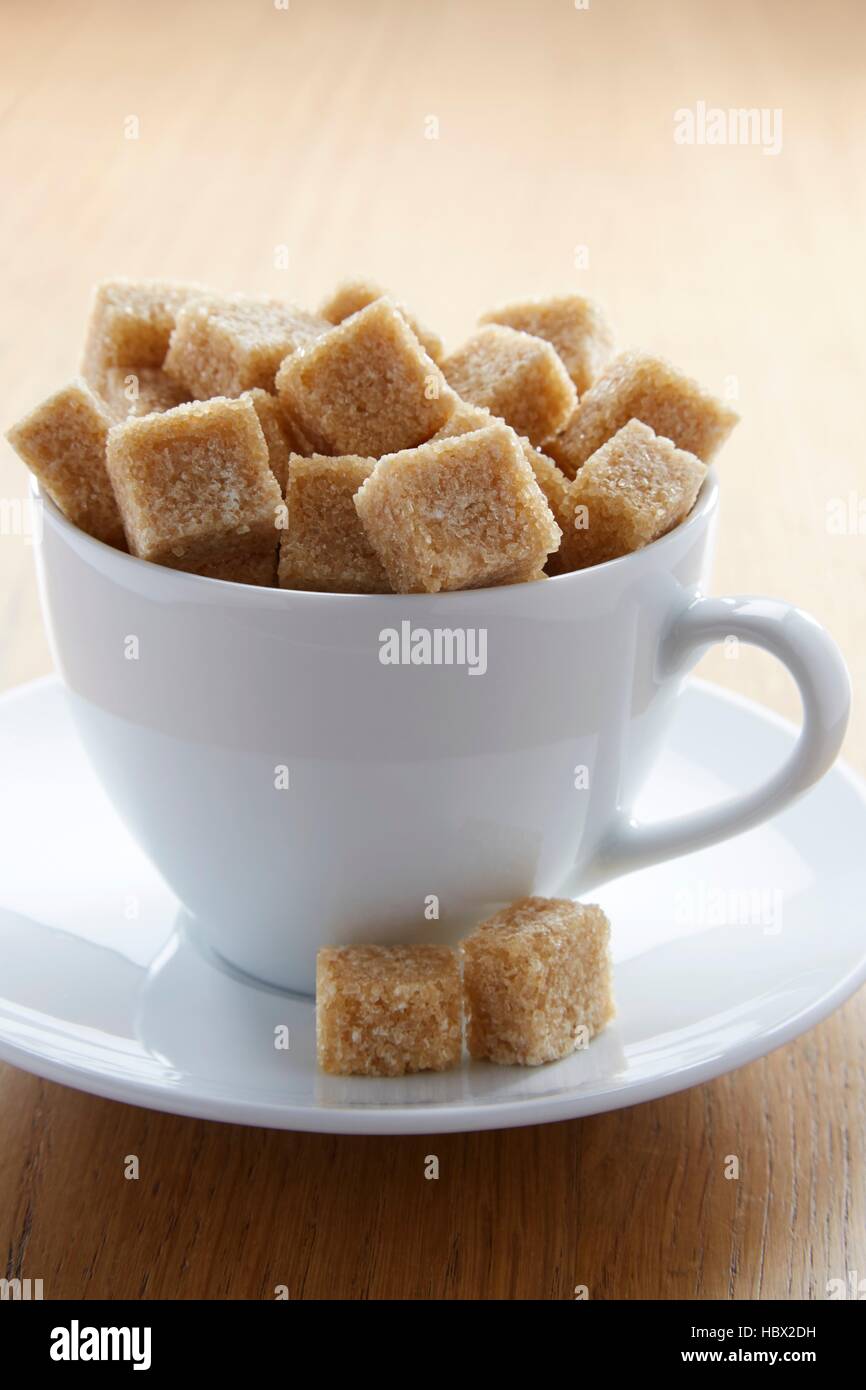 Tea cup full of sugar lumps, studio shot Stock Photo - Alamy