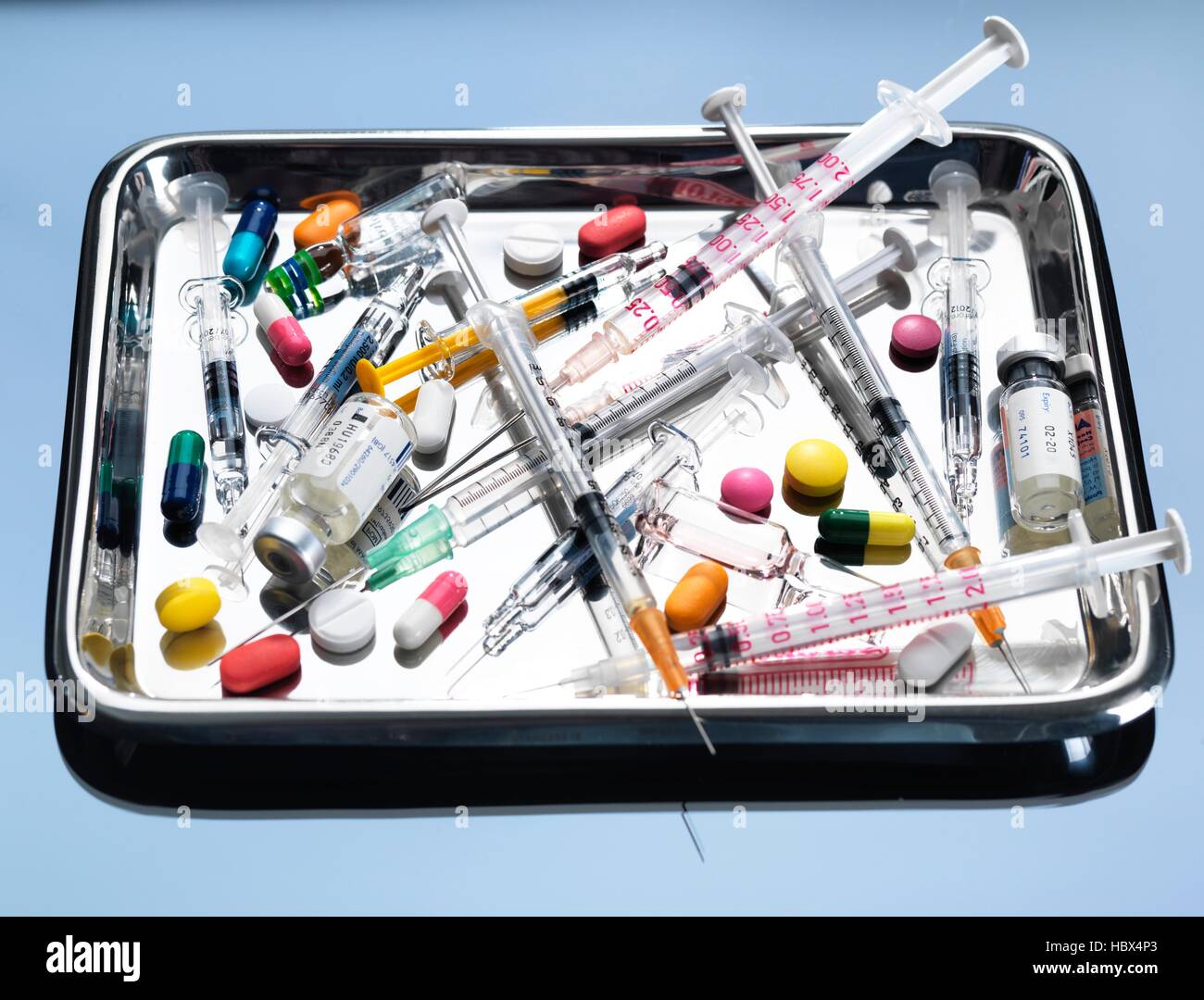 A variety of medical syringes, ampules and drugs on a medical tray ...