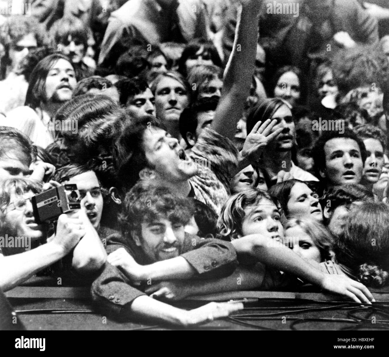 GIMME SHELTER, fans in the audience watching the Rolling Stones concert ...