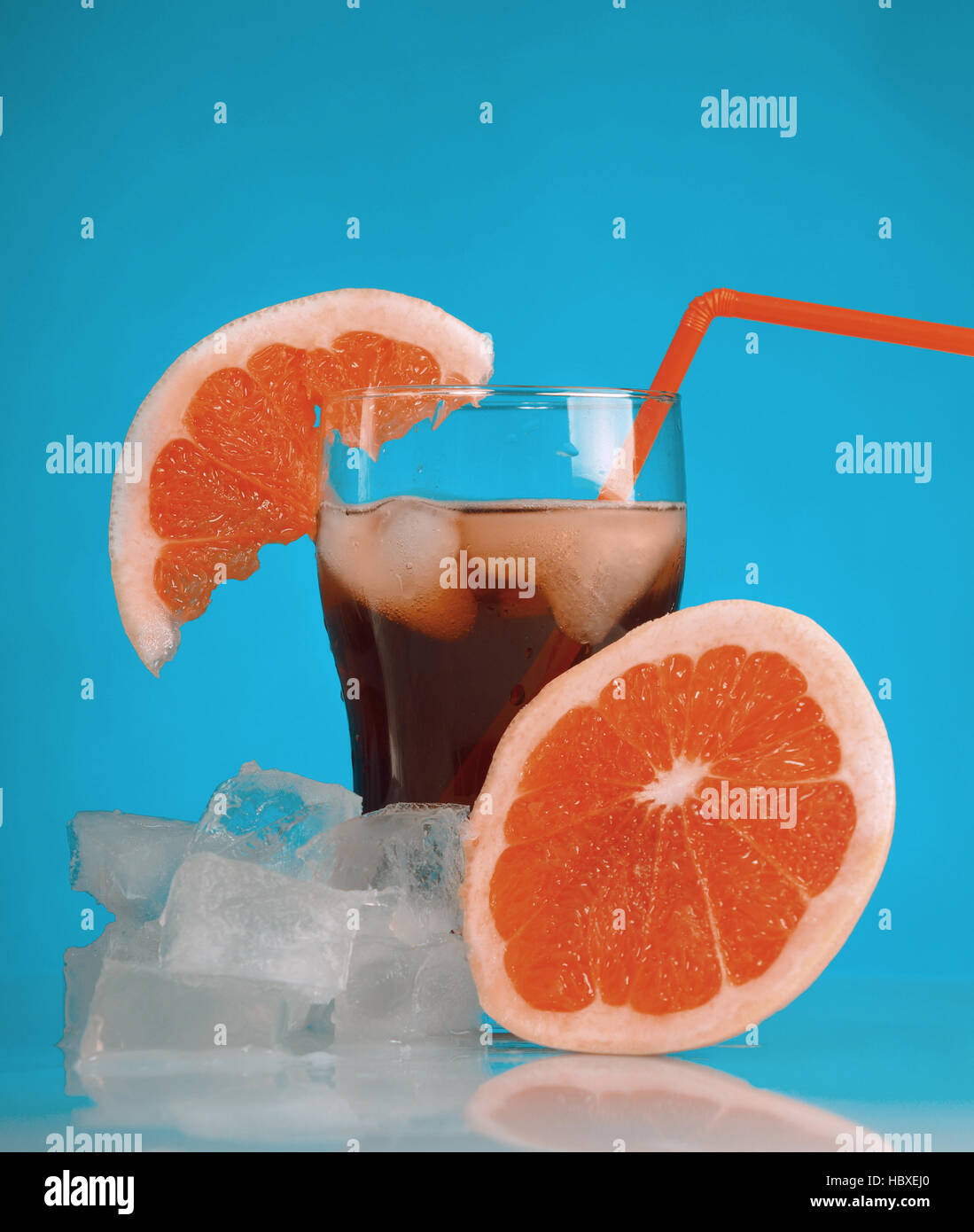 tropical red cold cocktail closeup on blue background Stock Photo - Alamy