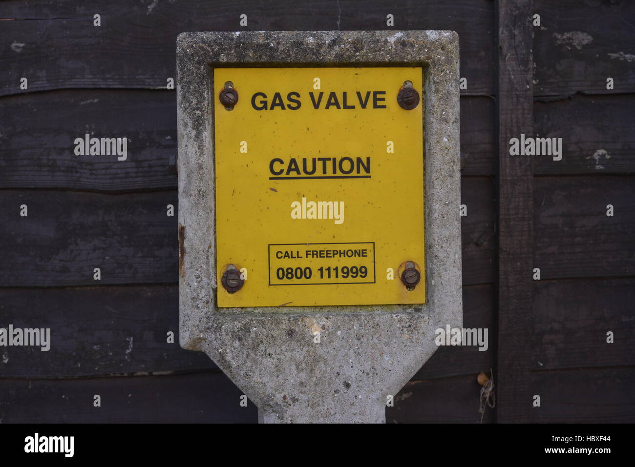 Gas valve, yellow street sign Stock Photo - Alamy