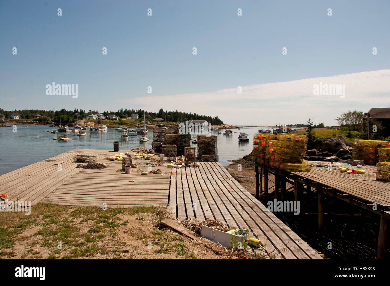 Lubec Town Harbor docks with Lobster traps on the pier. Lobster boats ...