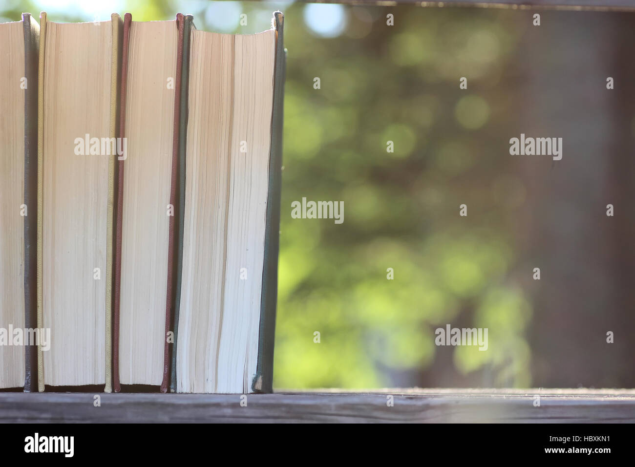book stack background table wooden outdoor Stock Photo - Alamy