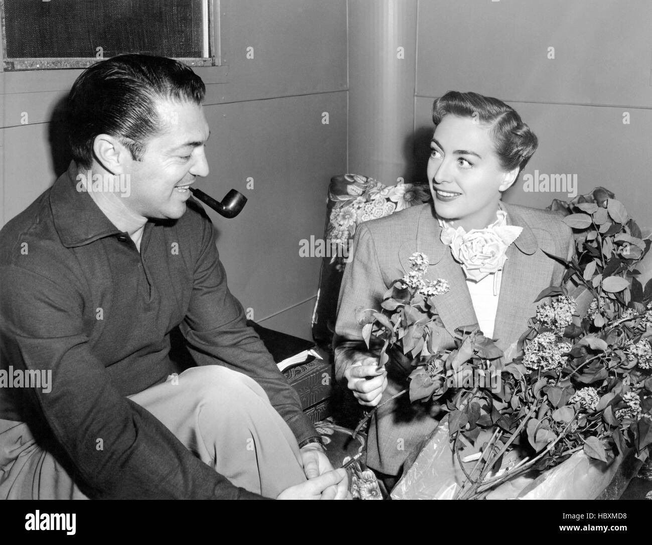 HARRIET CRAIG, director Vincent Sherman, Joan Crawford, admiring lilacs ...