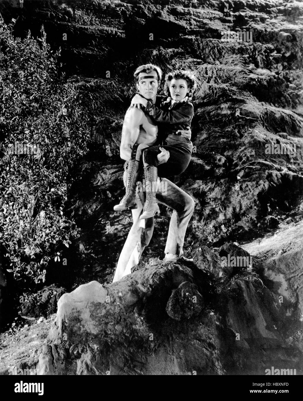 HAWK OF THE WILDERNESS, Bruce Bennett (aka Herman Brix), carrying ...