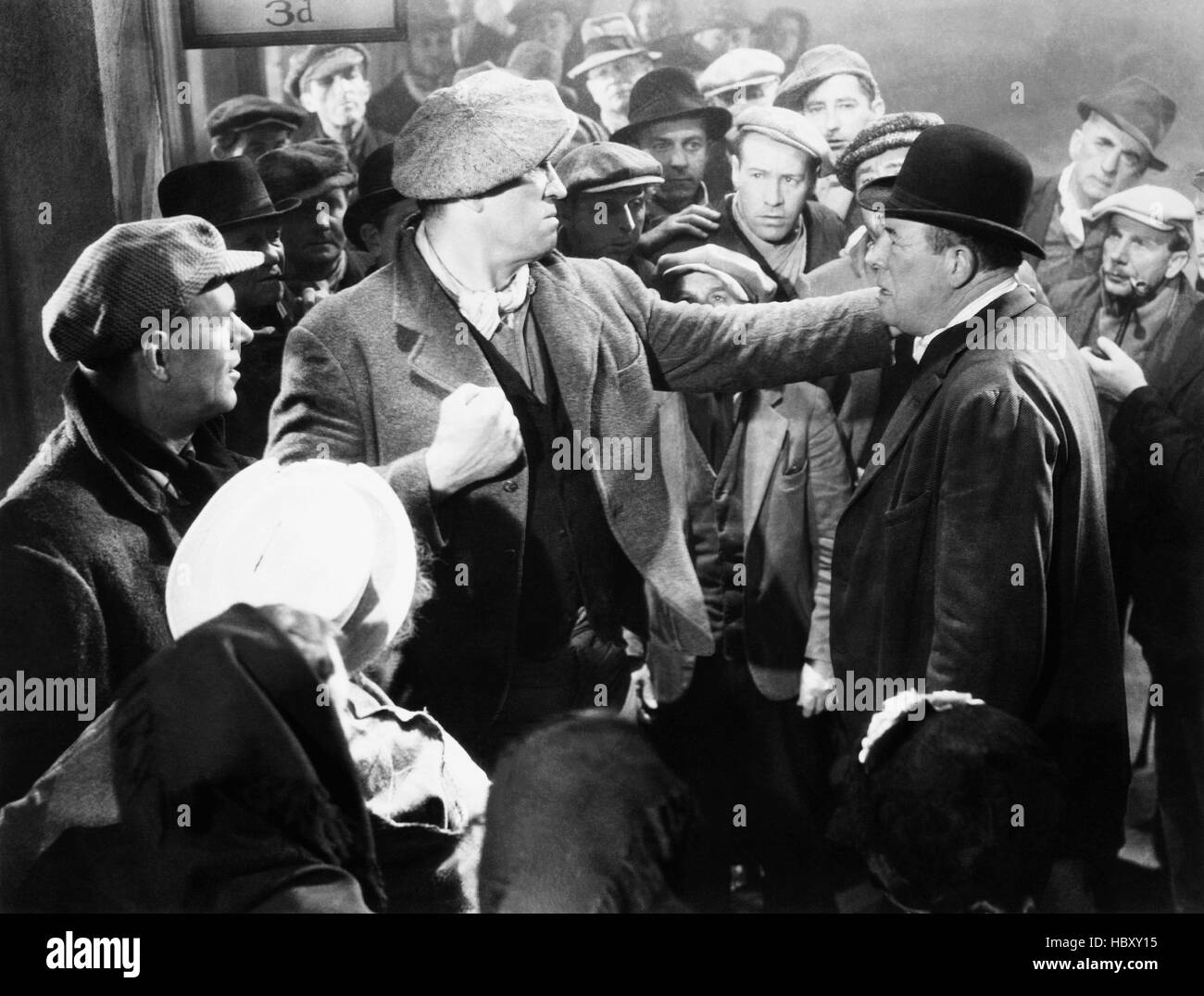 THE INFORMER, face to face from left: Victor McLaglen, Robert Homans ...