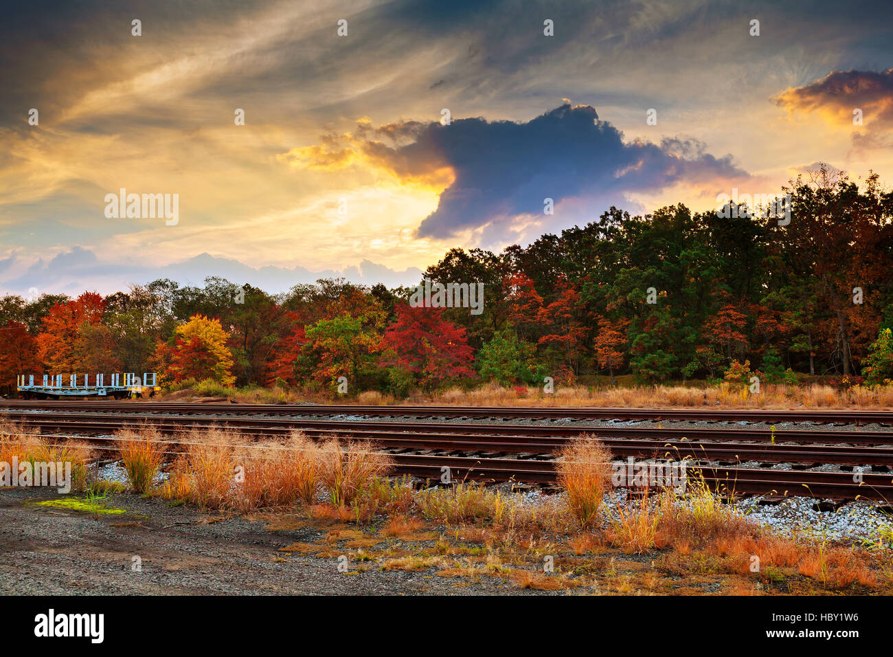 Colorful autumn sunset with sun rays coloring the clouds Stock Photo ...
