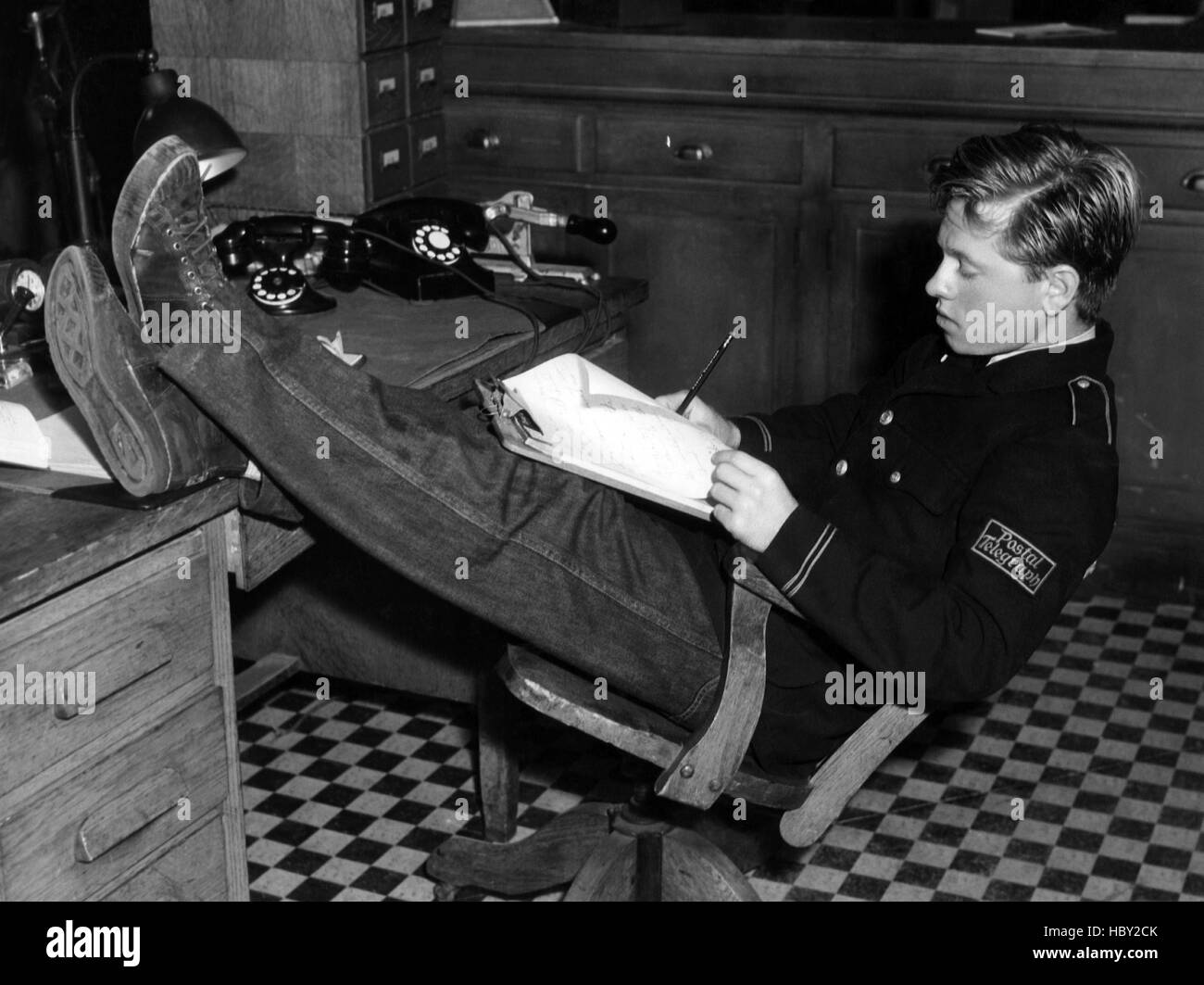 THE HUMAN COMEDY, Mickey Rooney doing homework, on set, 1943 Stock ...