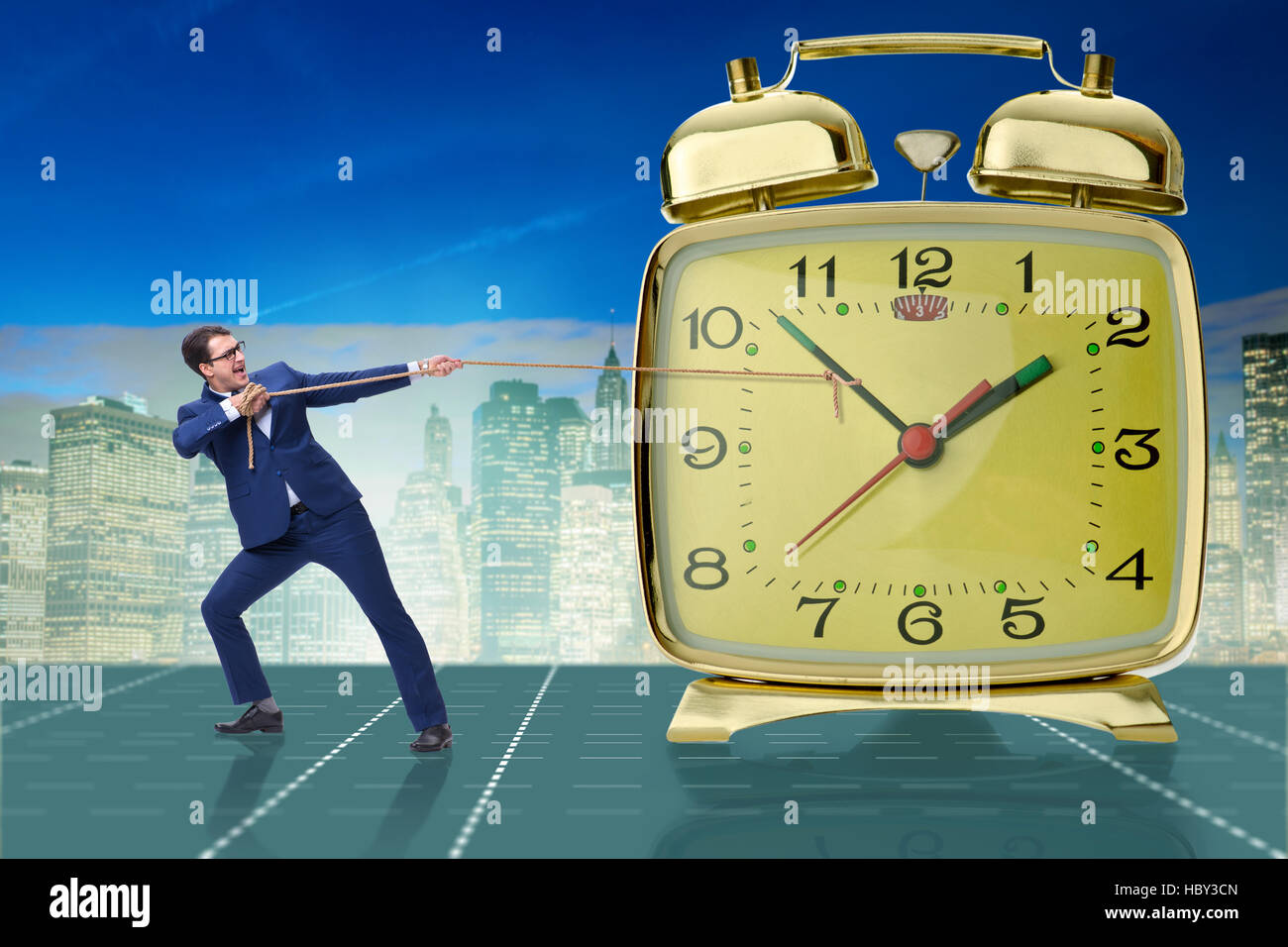Businessman pulling clock in time management concept Stock Photo - Alamy