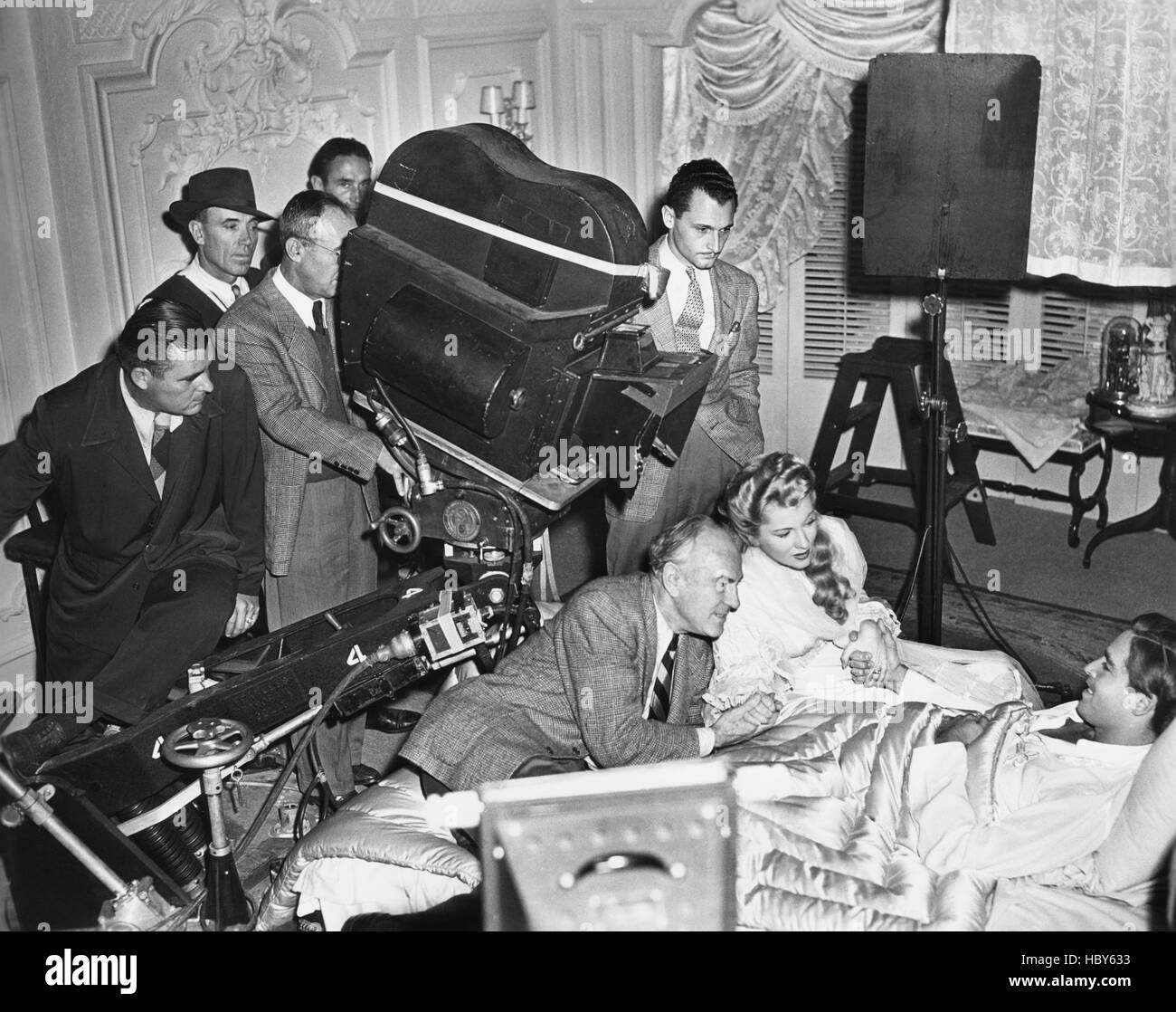 IVY, director Sam Wood, center, with Joan Fontaine, Richard Ney, on-set ...