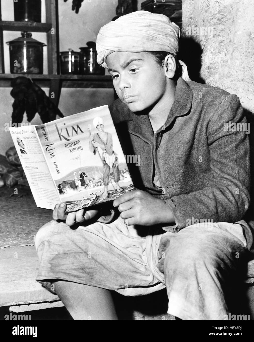 KIM, Dean Stockwell, reading the source novel on-set, May 1950 Stock ...