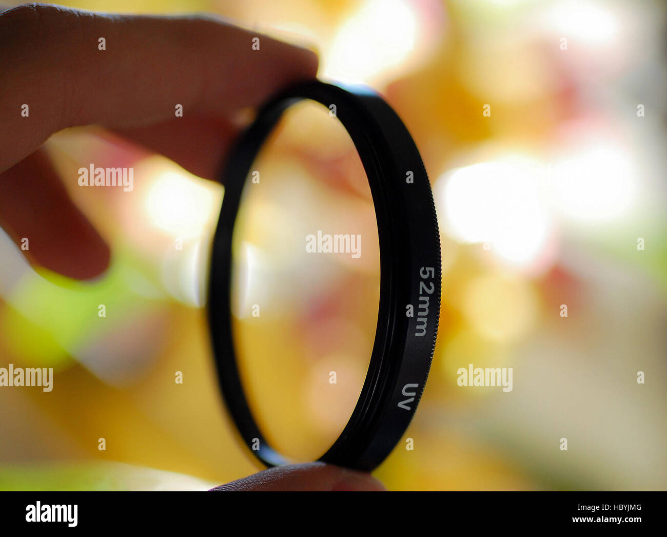 Camera lens filter being held Stock Photo - Alamy