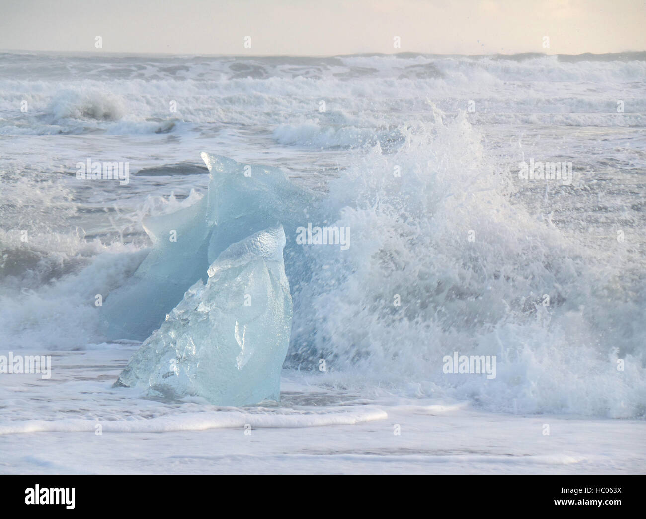 Wave hitting icebergs on the beach of South Iceland Stock Photo - Alamy