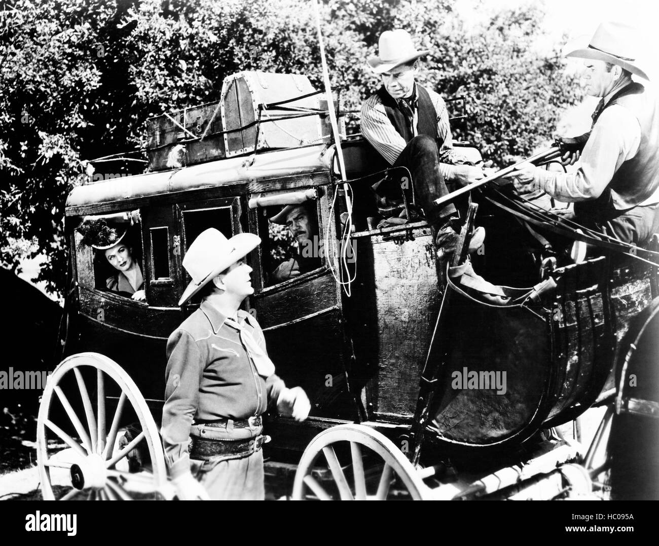 MAN FROM SONORA, Johnny Mack Brown (standing), in stagecoach from left ...