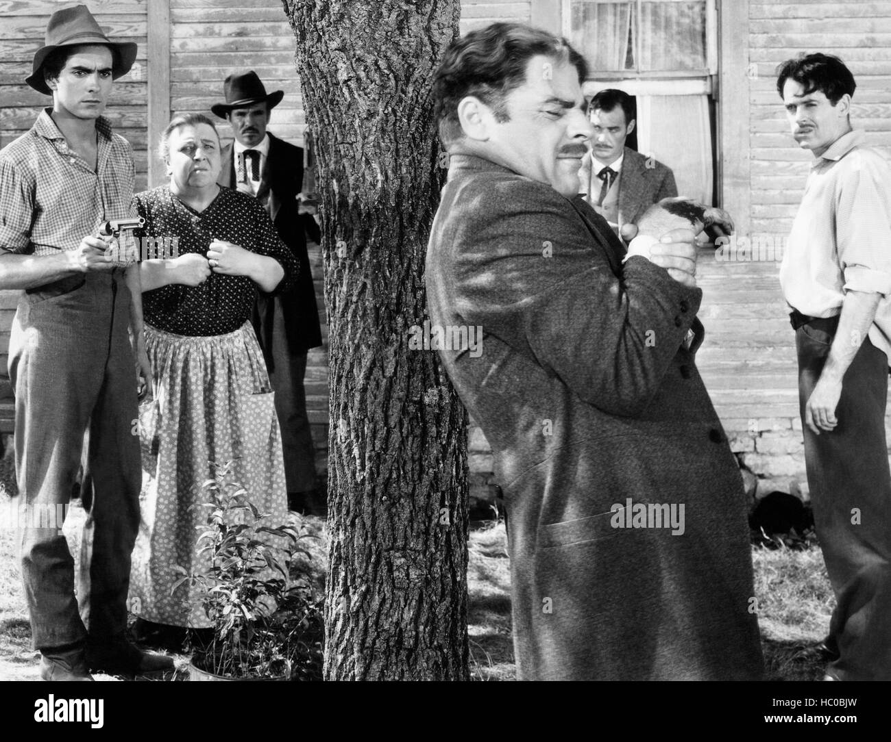 JESSE JAMES, Tyrone Power (gun), Jane Darwell (apron), Brian Donlevy ...