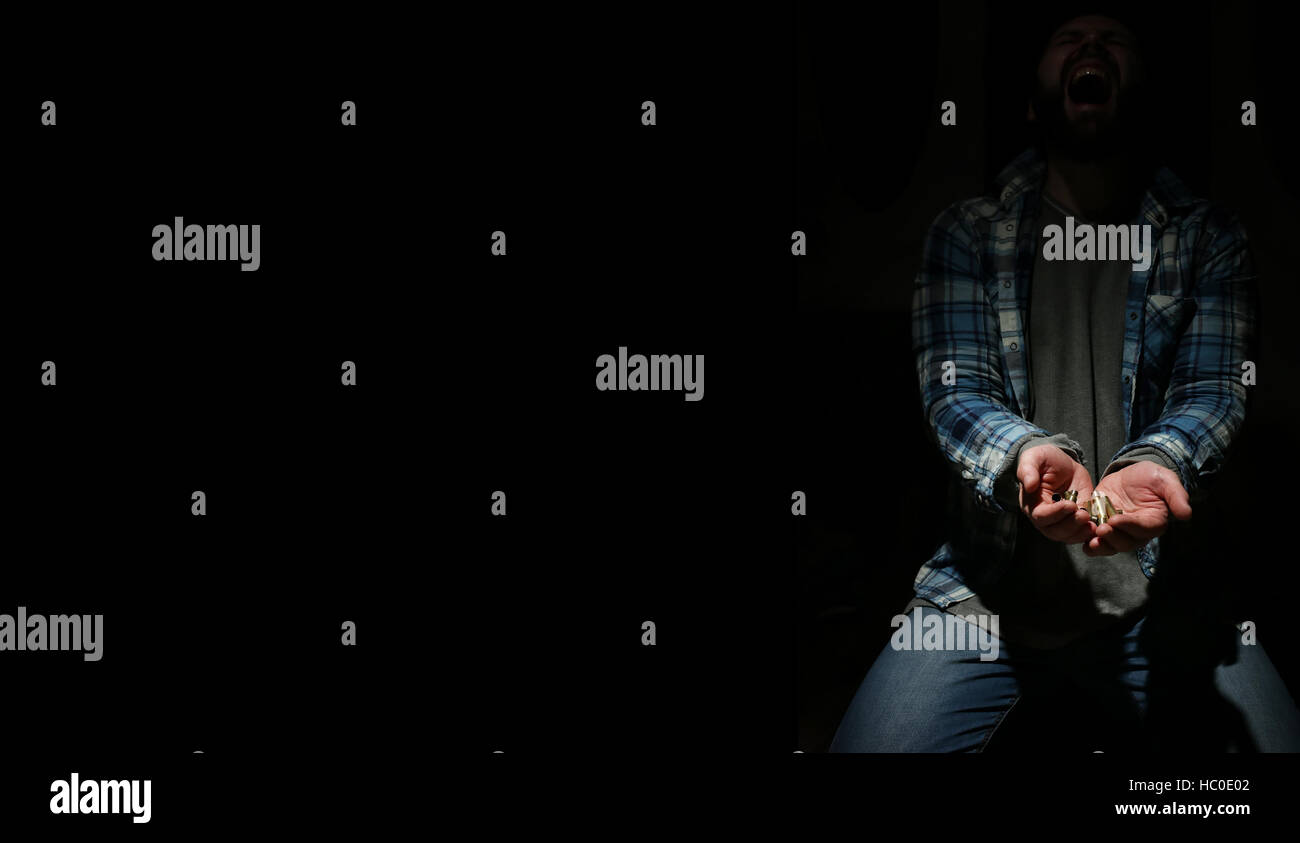 black background with bullet in hands man Stock Photo - Alamy