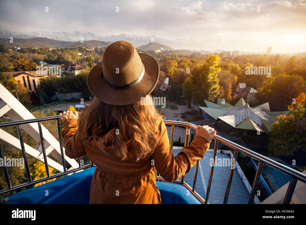 Woman with hat at the cabin of Ferris wheel in the autumn park at ...