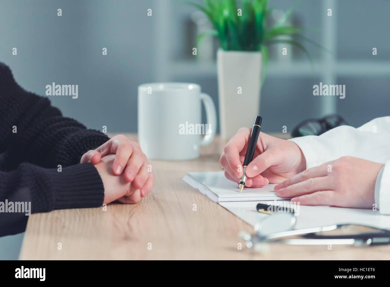Woman patient applying for medical exam at female doctor's office ...