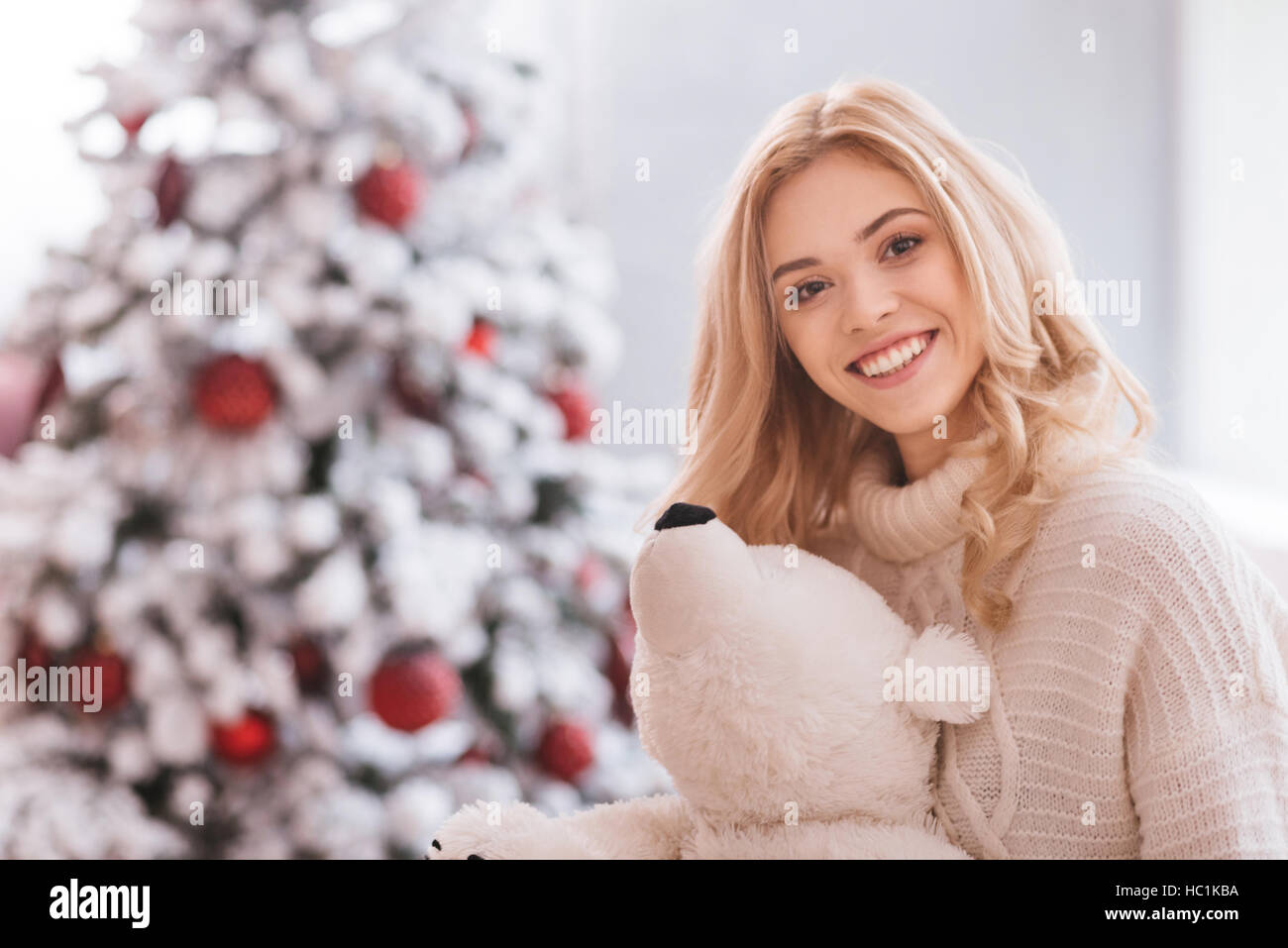 Cheerful charming woman holding a stuffed animal Stock Photo - Alamy