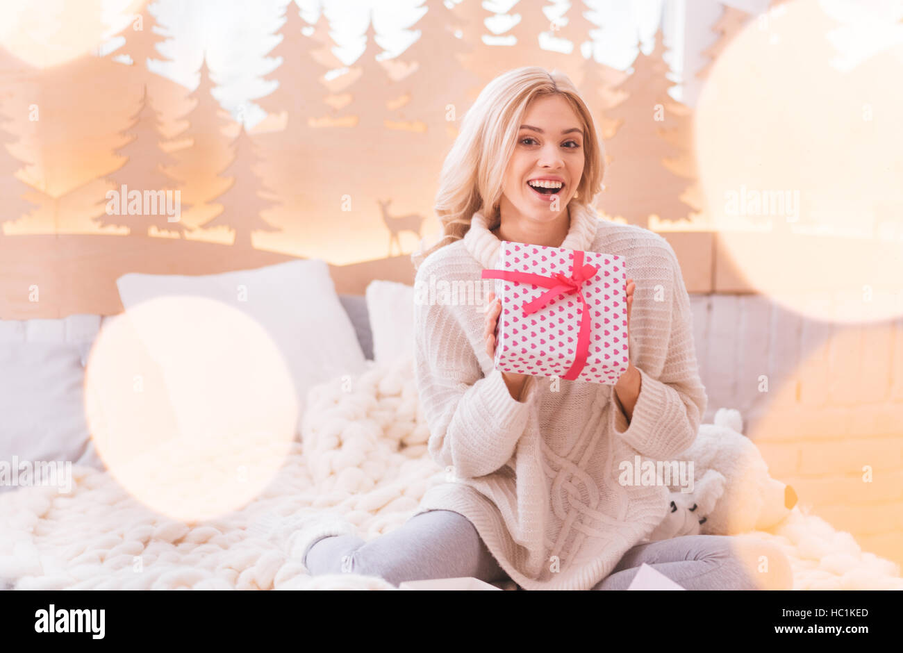 Joyful happy woman showing her present to you Stock Photo - Alamy