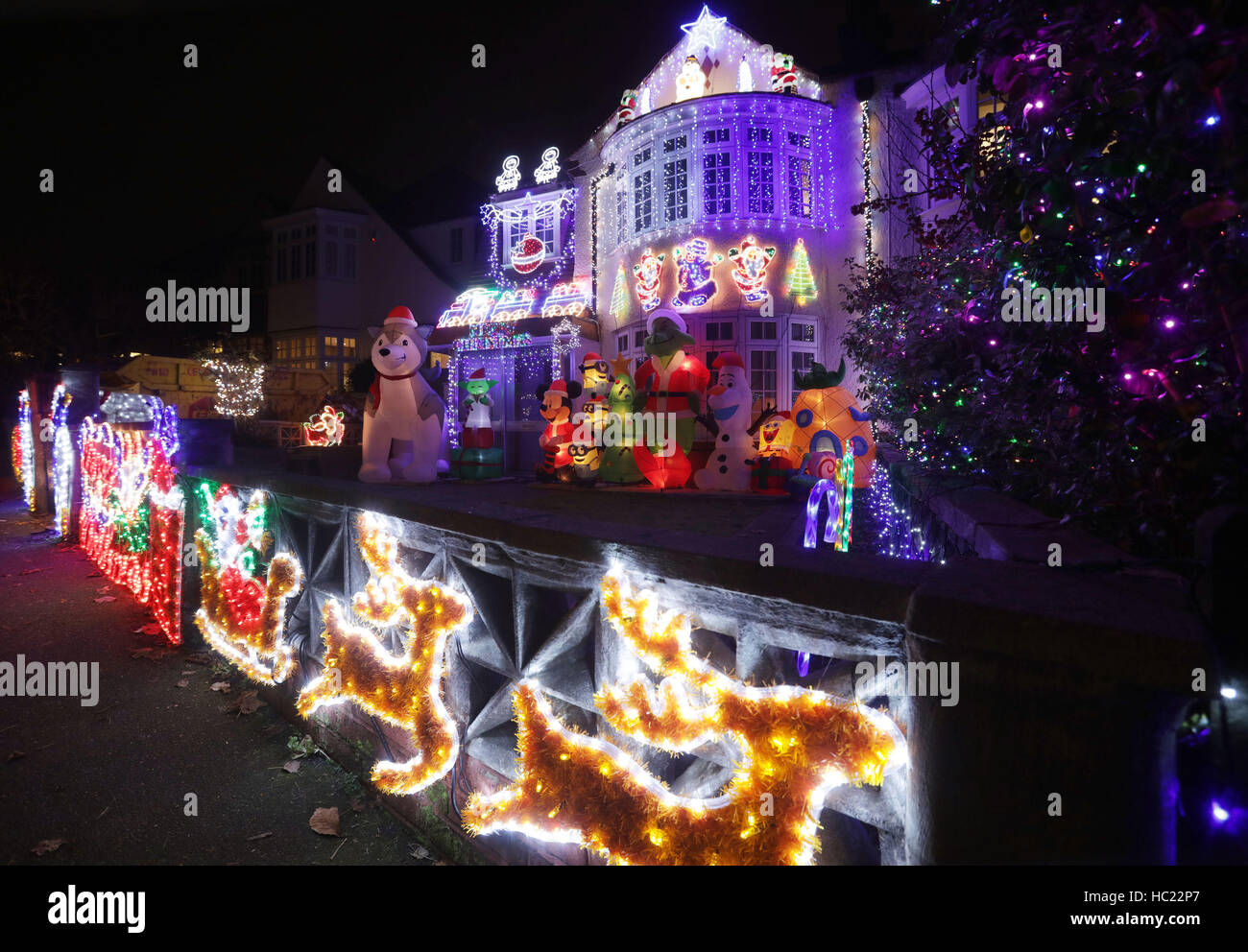 A residential house decorated with Christmas lights and festive cartoon ...