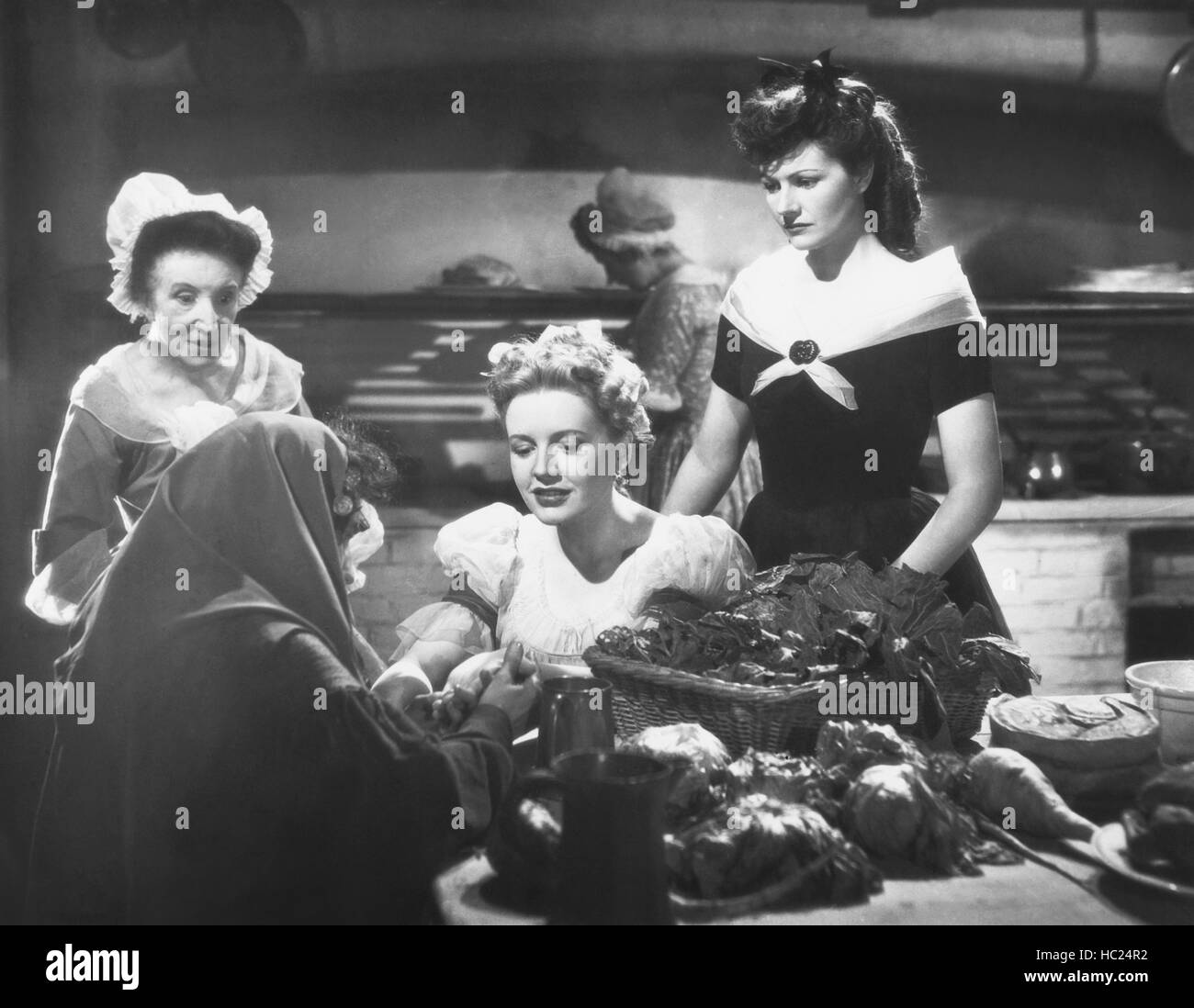 THE MAN IN GREY, front from left: Beatrice Varley (back to camera ...