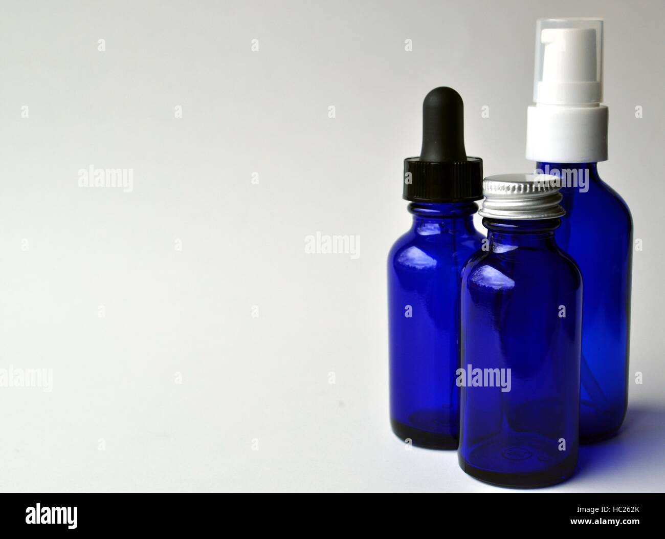 Group of dark blue cosmetic glass bottles for essential oils ...