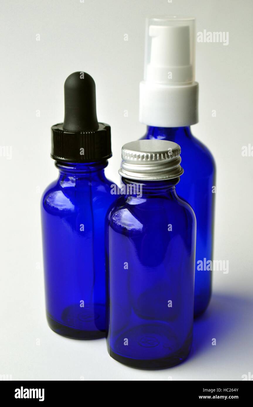 Group of dark blue cosmetic glass bottles for essential oils ...