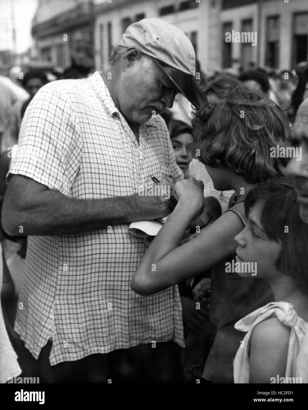 THE OLD MAN AND THE SEA, Ernest Hemingway on set in Cuba signing an ...