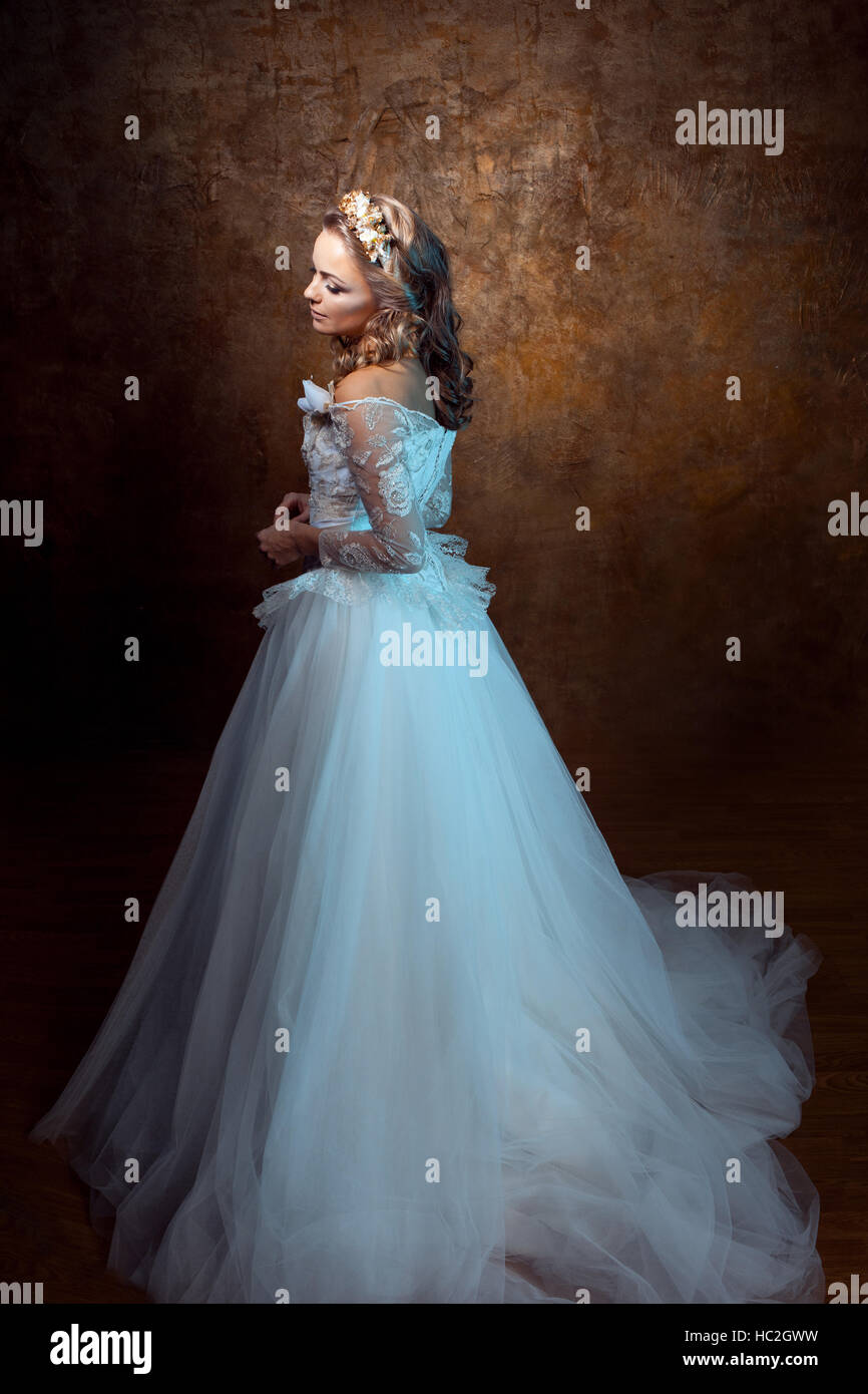 Beautiful girl bride in luxurious wedding dress. Portrait in profile ...