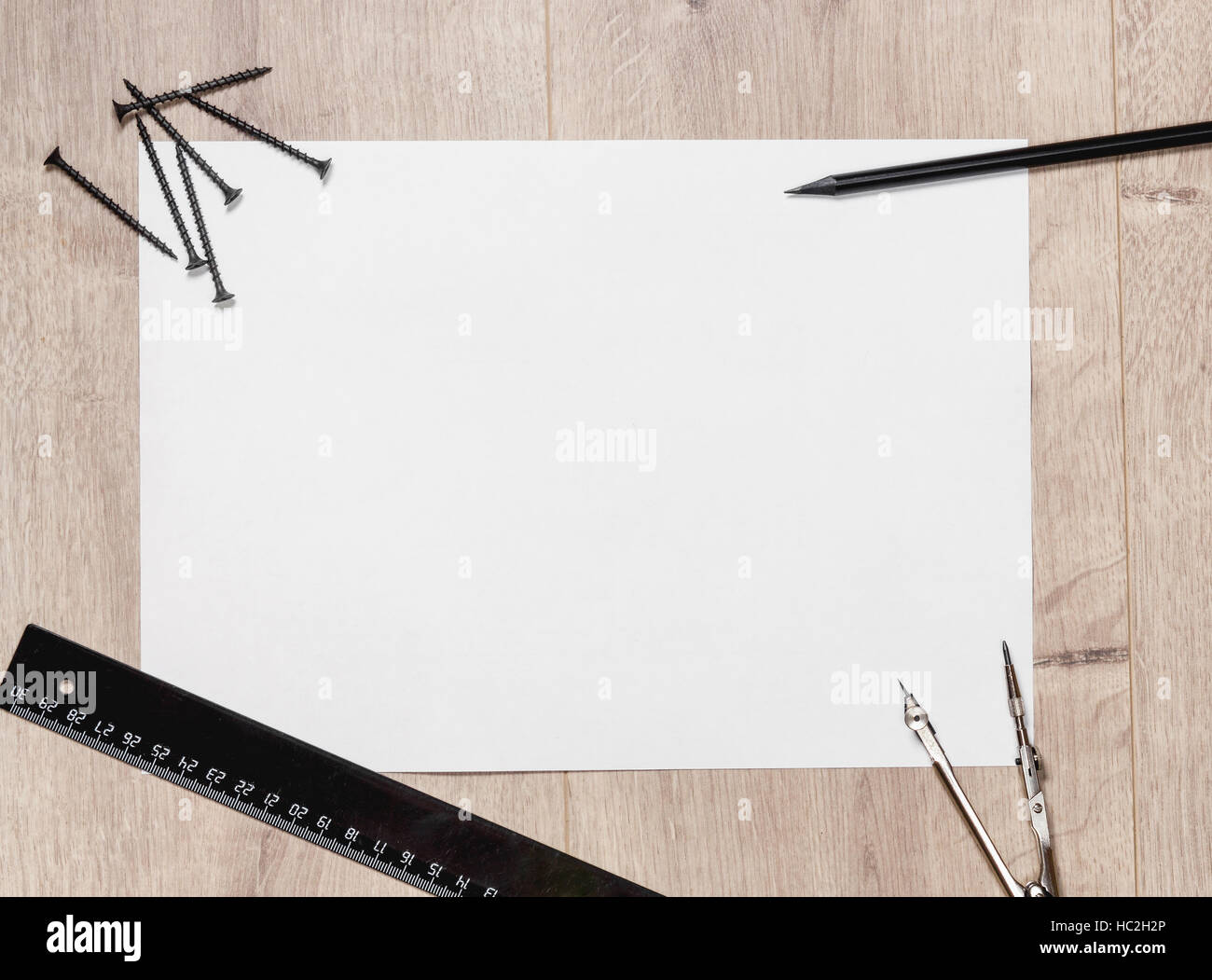 Flat composition of empty drawing sheet and screws, a ruler, pencil ...