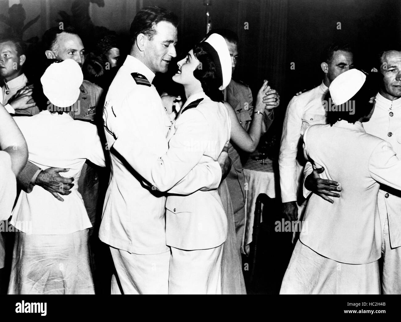 OPERATION PACIFIC, face to face from left: John Wayne, Patricia Neal ...