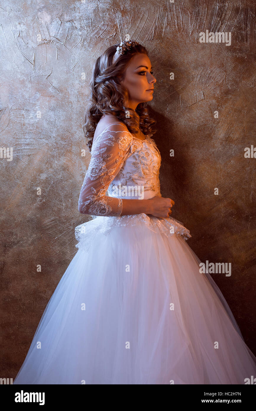 Beautiful girl bride in luxurious wedding dress. Portrait in profile ...