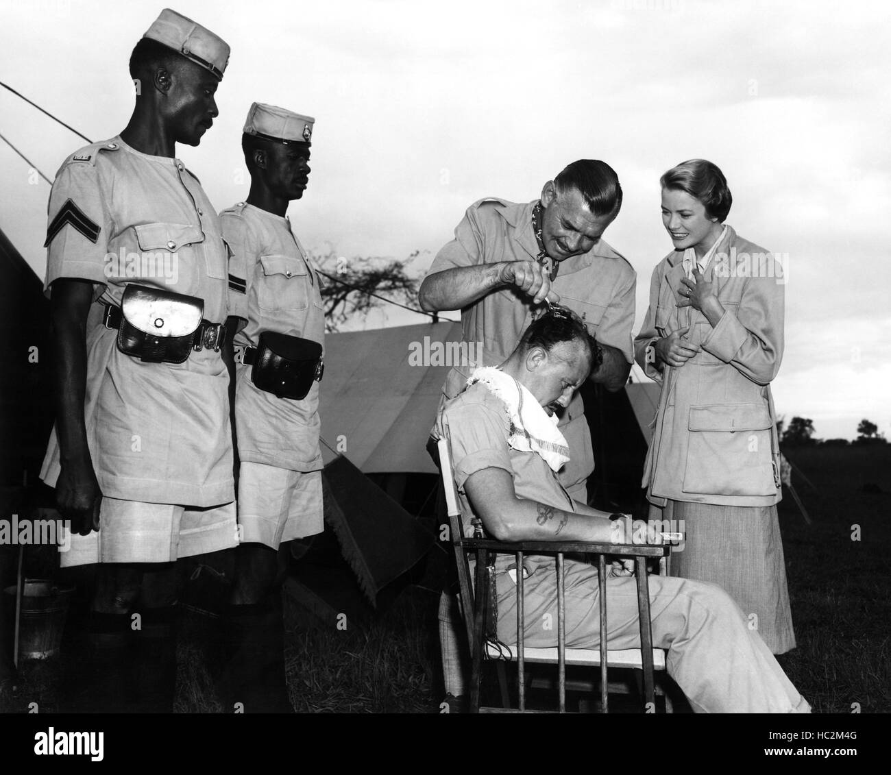 MOGAMBO, Clark Gable on location shaving head of makeup artist, Colin ...