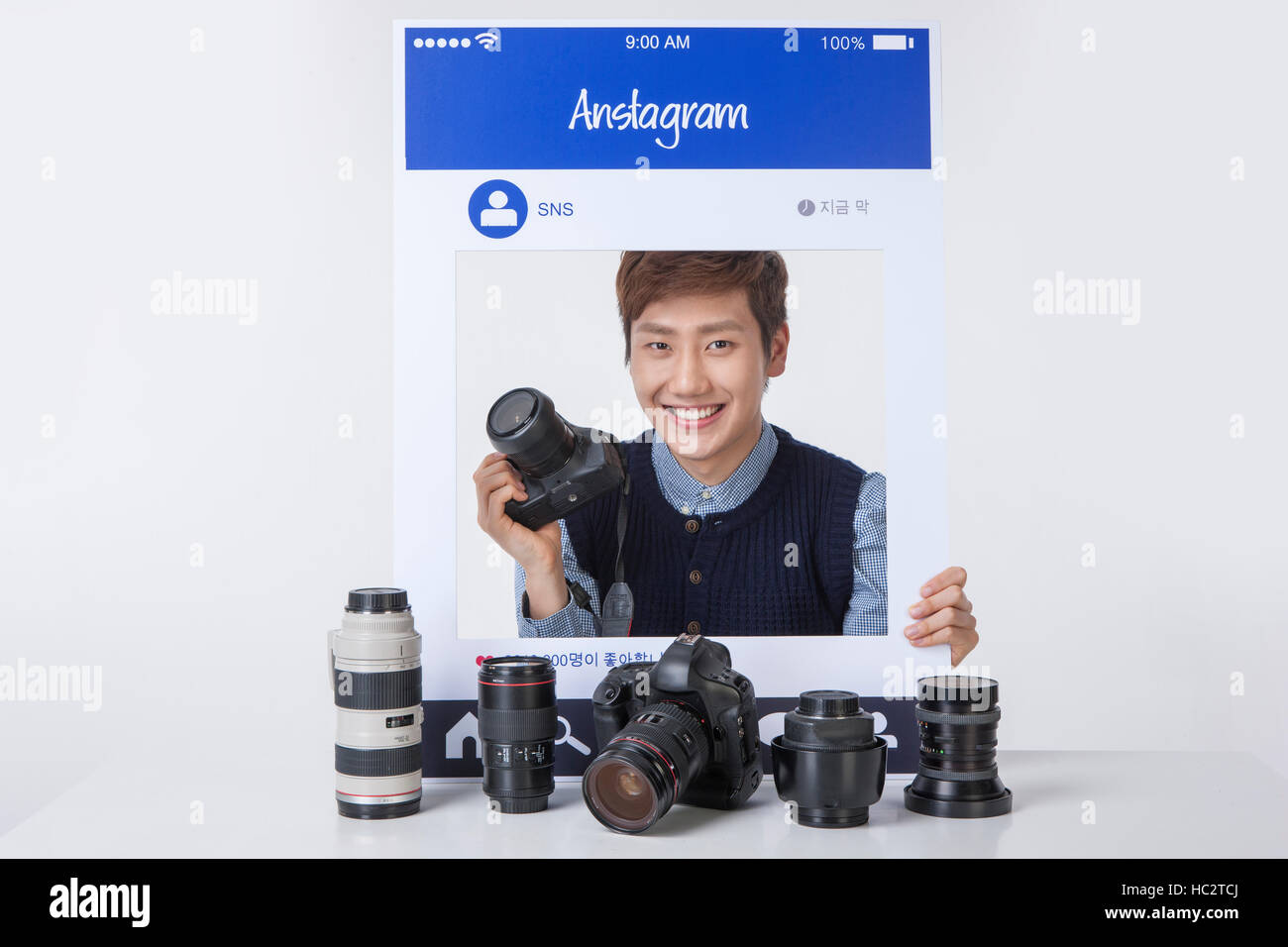 Portrait of young smiling Korean man showing a camera on SNS Stock ...
