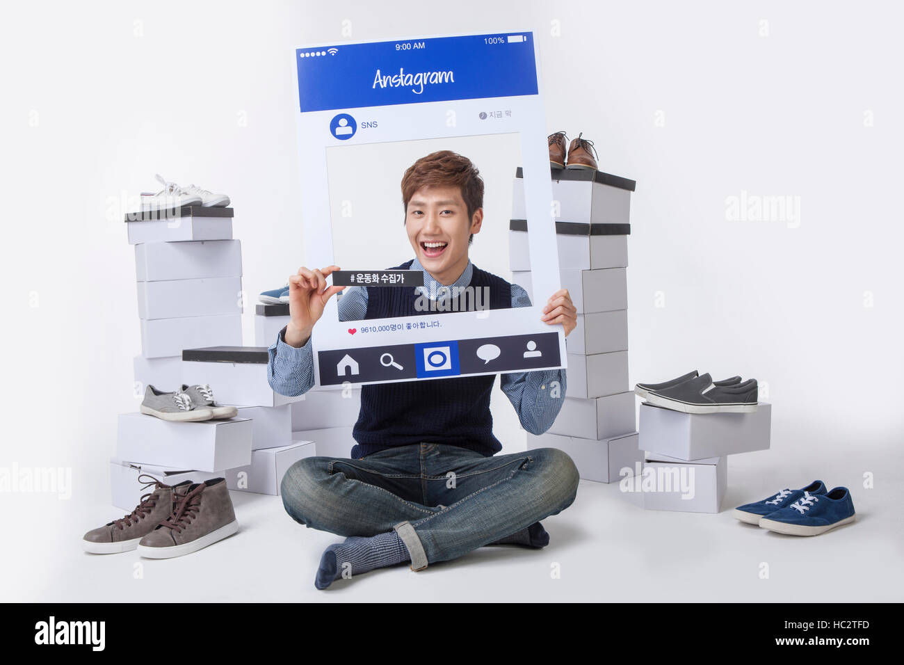 Portrait of young smiling man collecting sneakers on SNS Stock Photo ...