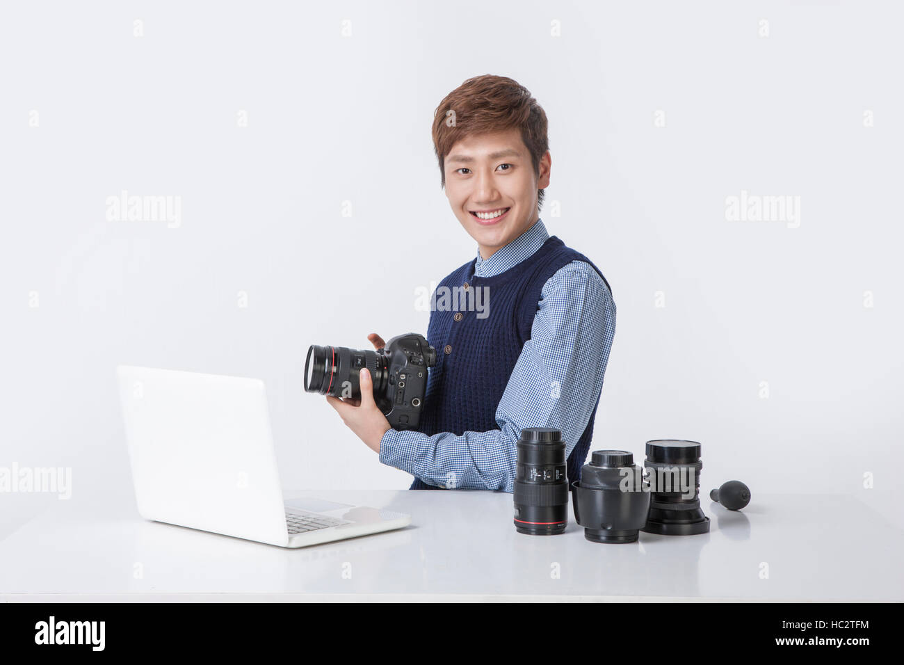 Portrait of young smiling man collecting cameras Stock Photo - Alamy